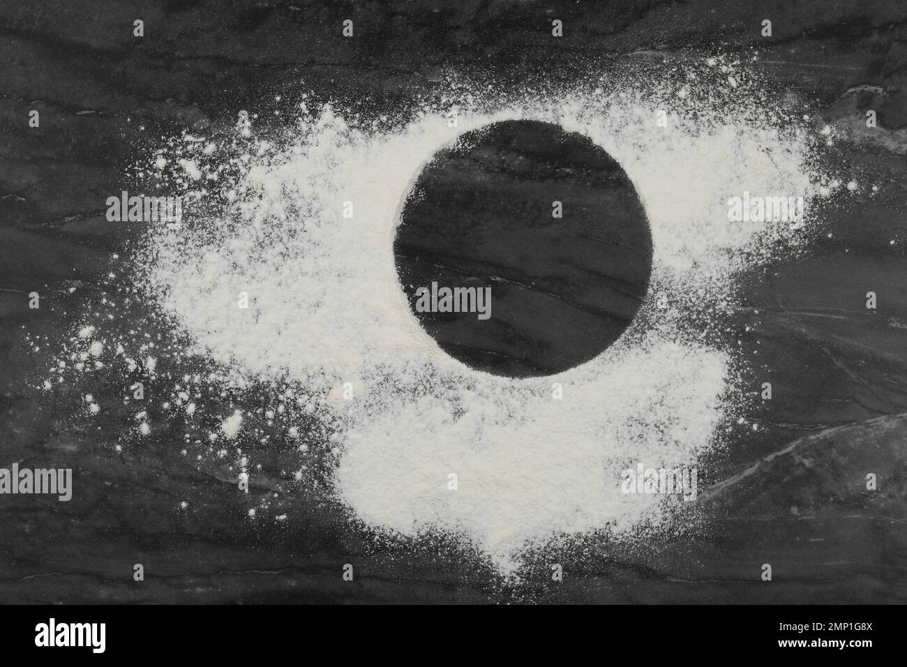 Frame made with flour on grey marble table, top view. Space for text ...