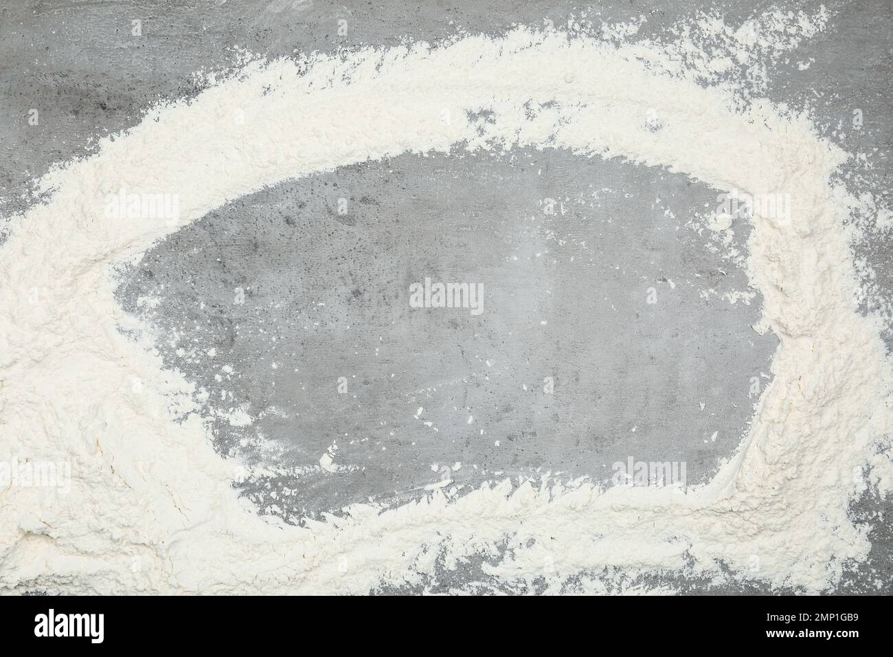 Frame made with flour on light grey table, top view. Space for text ...