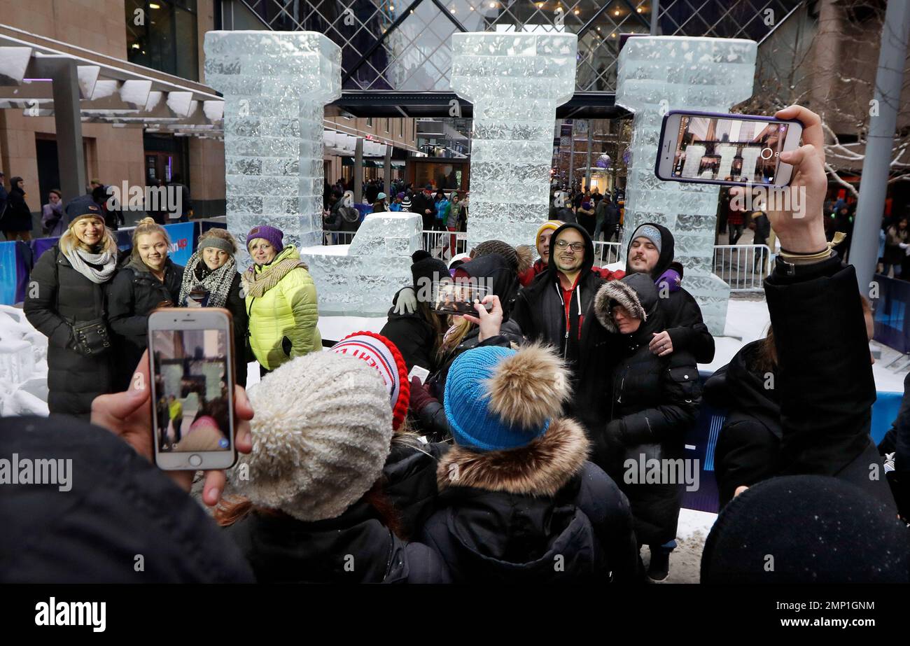 Fans take pictures in front of the Roman numeral LII ice sculpture ...