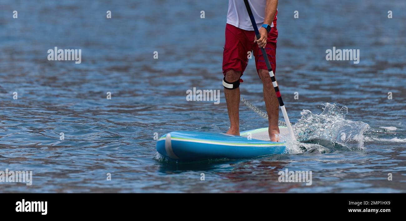 Stand up paddle board man paddle boarding on ocean Stock Photo - Alamy
