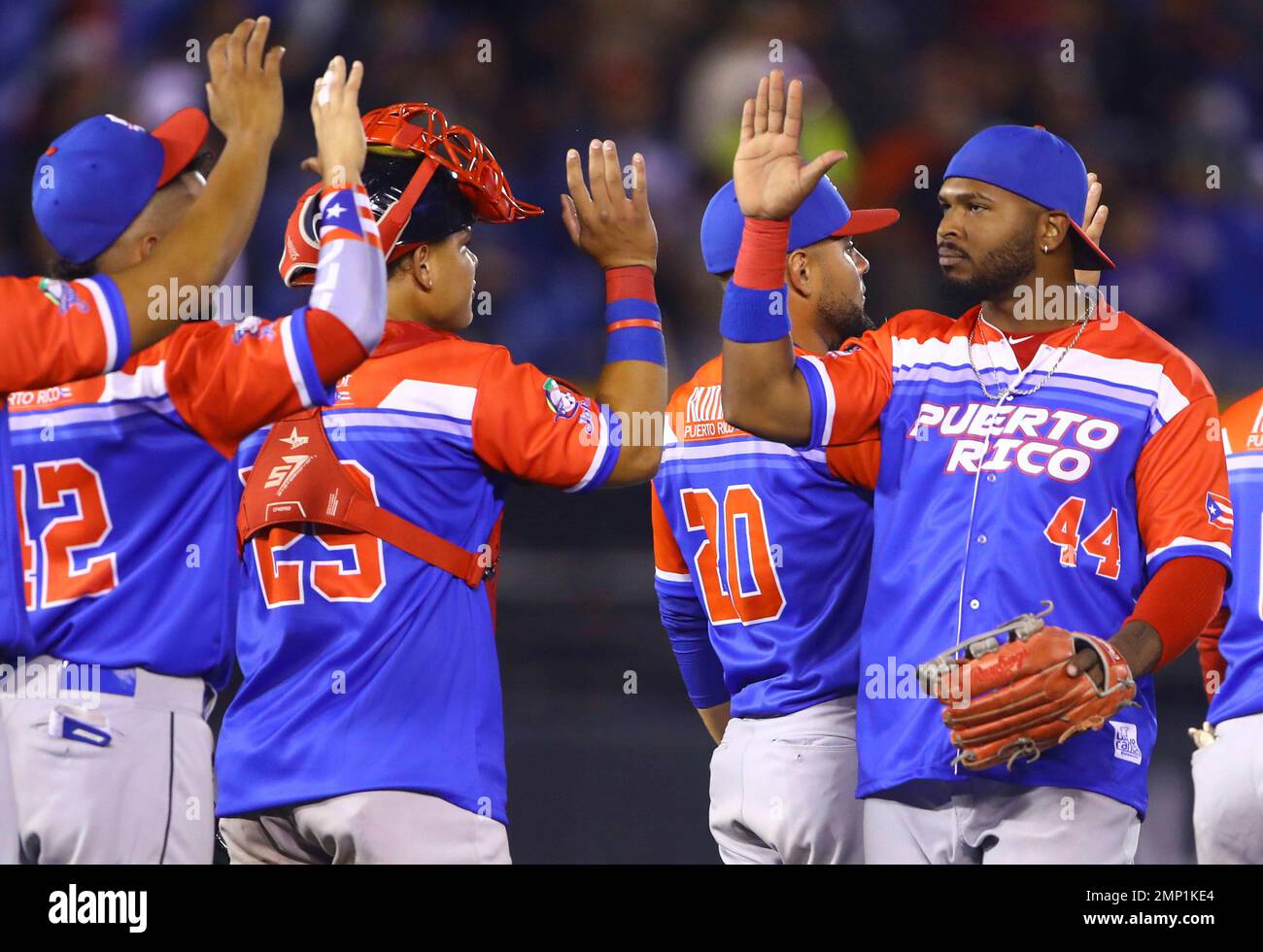 Anthony Garcia, right, of Puerto Rico's Criollos de Caguas, celebrates ...