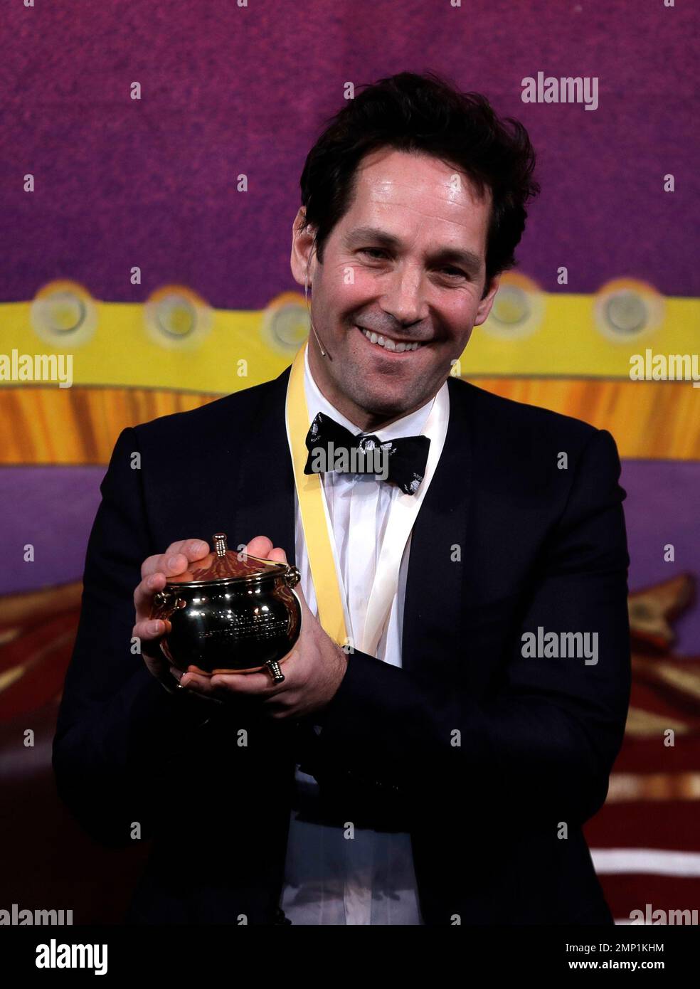 Actor Paul Rudd holds his pudding pot trophy during a roast at Harvard ...