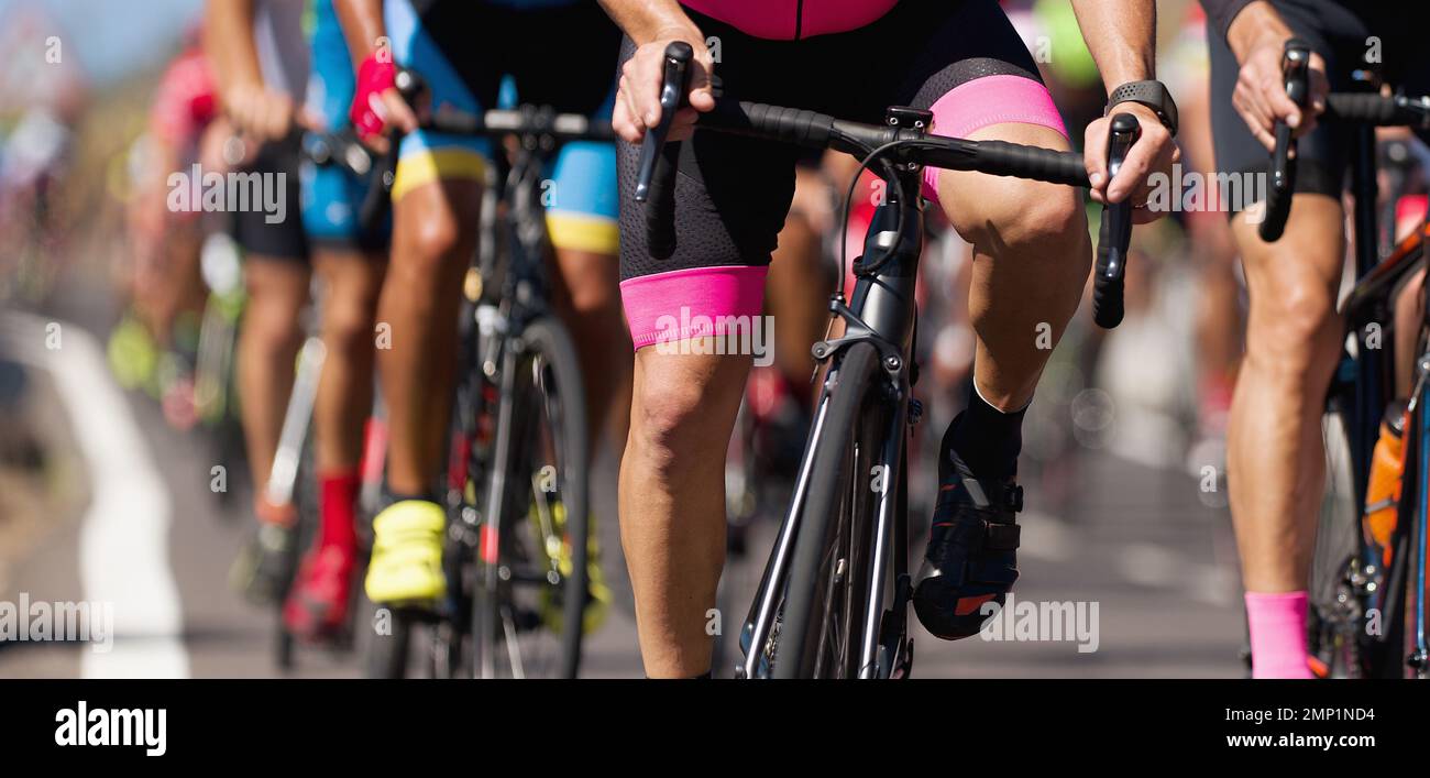Cycling competition, cyclist athletes riding a race, climbing up a hill ...