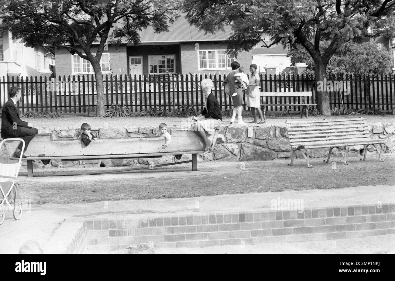 A scene in a white-only park in Johannesburg, South Africa as a mother ...