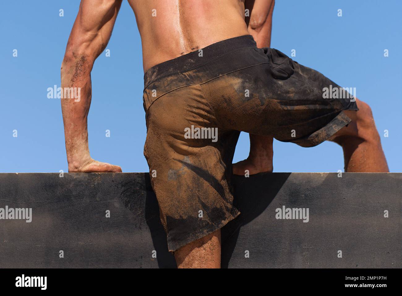 Mud race runners running over obstacles extreme sport Stock Photo - Alamy