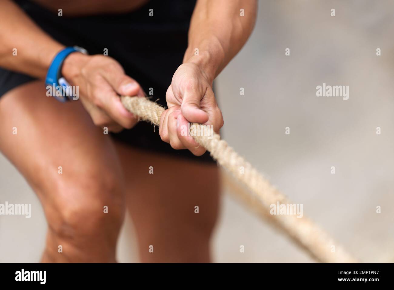 Mud race runners,defeating obstacles by using ropes,tug of war Stock ...