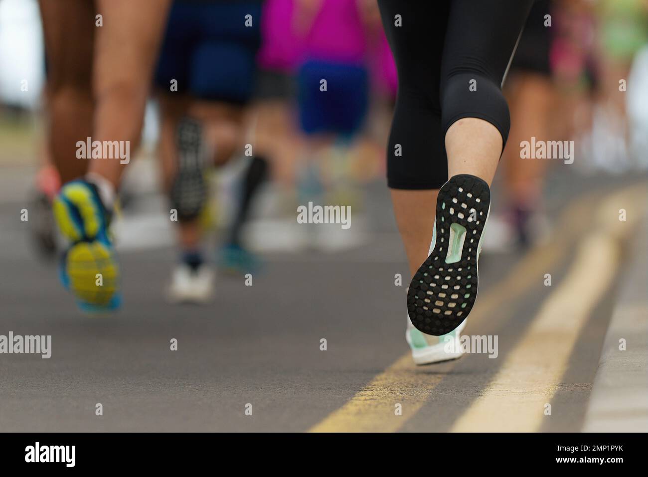 Marathon runners running on city road, large group of runners Stock ...