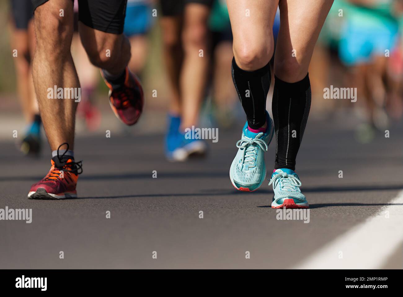 Marathon running race, people feet on city road Stock Photo - Alamy