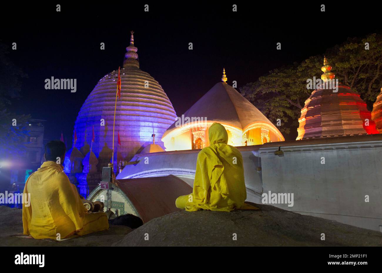 Indian devotees offer prayer during the lunar eclipse and Maghi Purnima ...