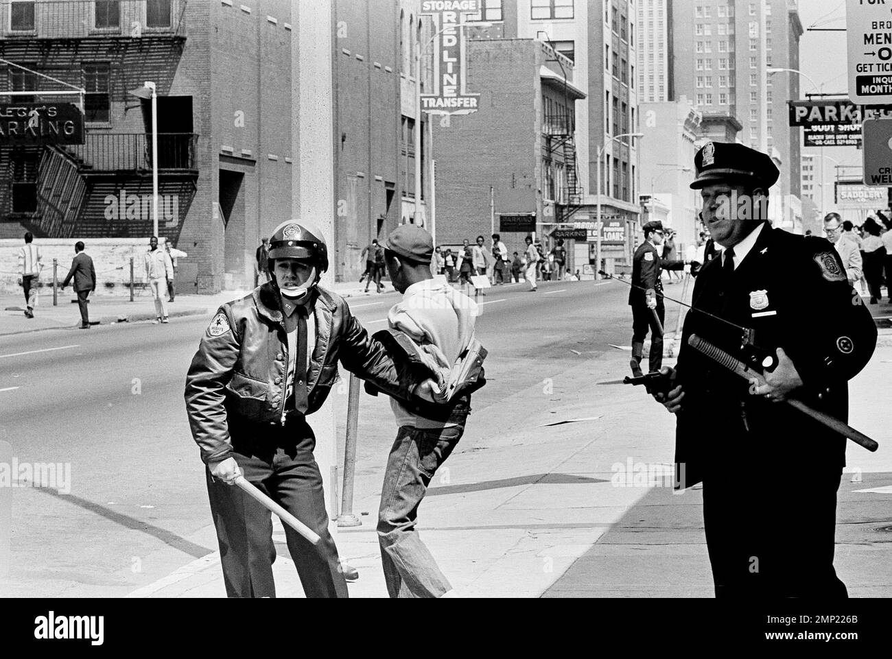 FILE-In this March 28, 1968 file photo, a policeman, right, holds his ...