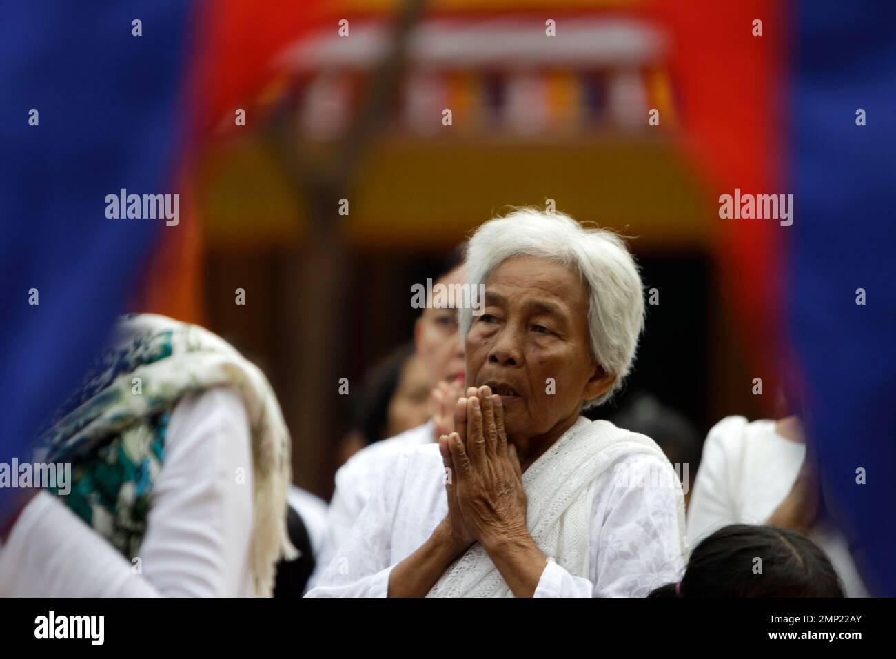A Cambodian Buddhist follower pray during Meak Bochea celebrations at ...
