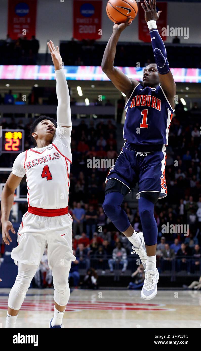 Auburn guard Jared Harper (1) shoots over Mississippi guard Breein Tyree (4) during the first ...