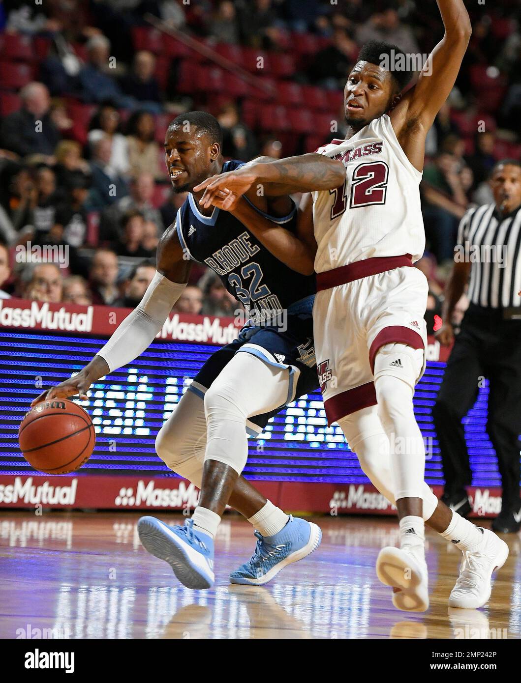 Rhode Island's Jared Terrell, left, dribbles around Massachusetts' Carl ...