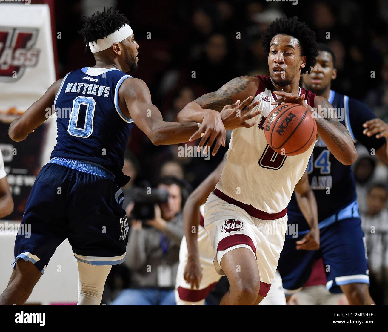 Massachusetts' Malik Hines, right, steals the ball from Rhode Island's ...
