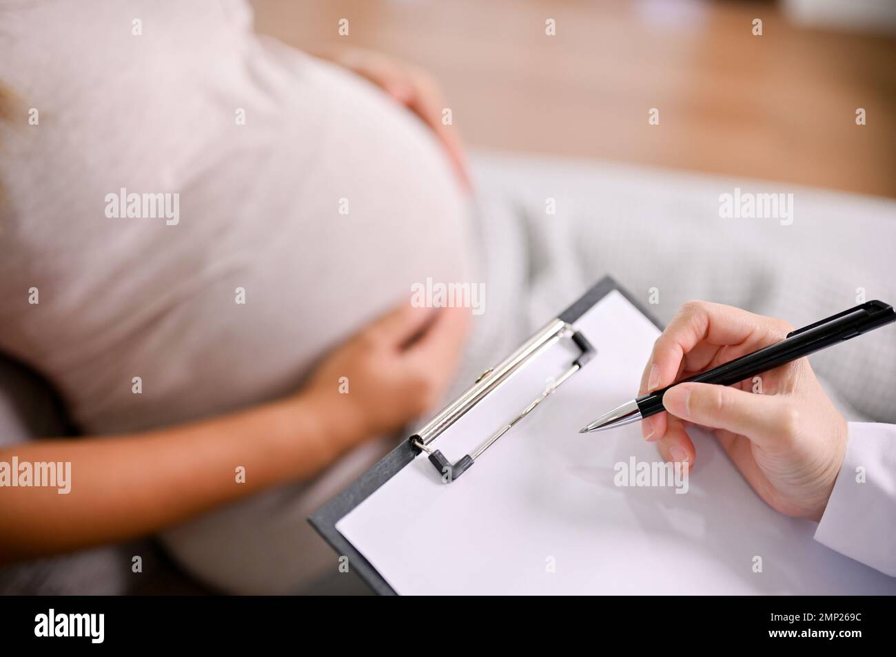 Close-up image of a professional female doctor checks on her pregnant ...