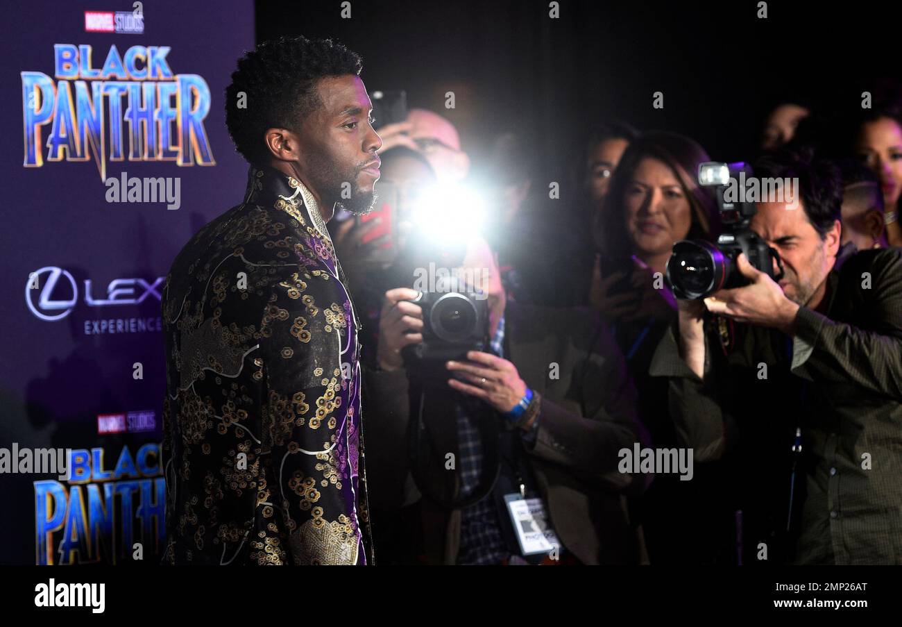 Chadwick Boseman, a cast member in "Black Panther," is trailed by ...