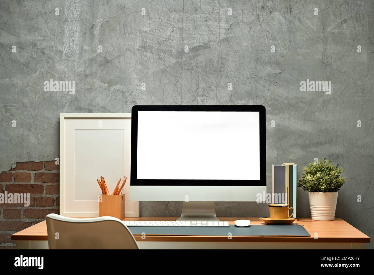 Blank computer monitor, picture frame, books, pencil holder and ...