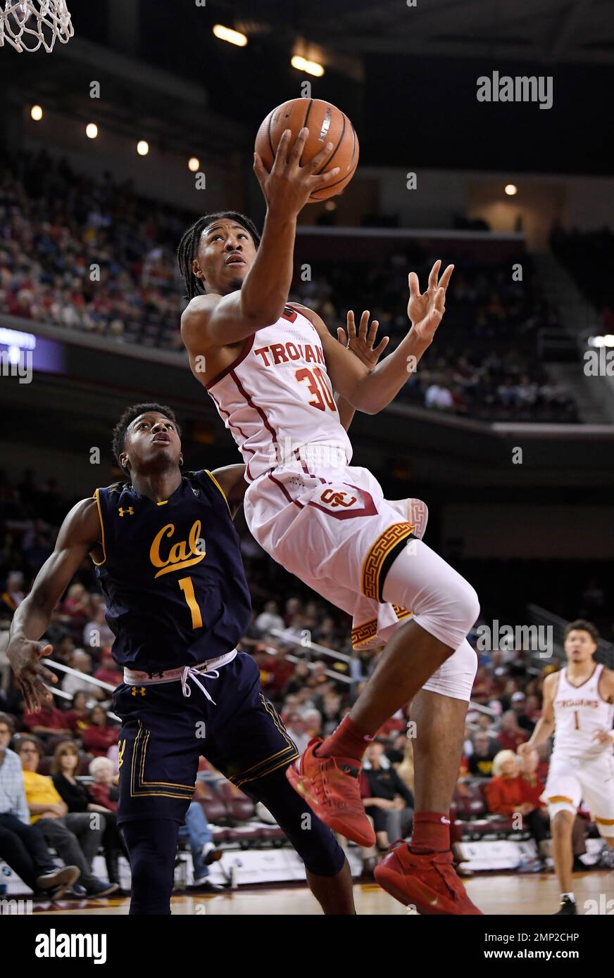 Southern California guard Elijah Stewart, right, shoots as California ...