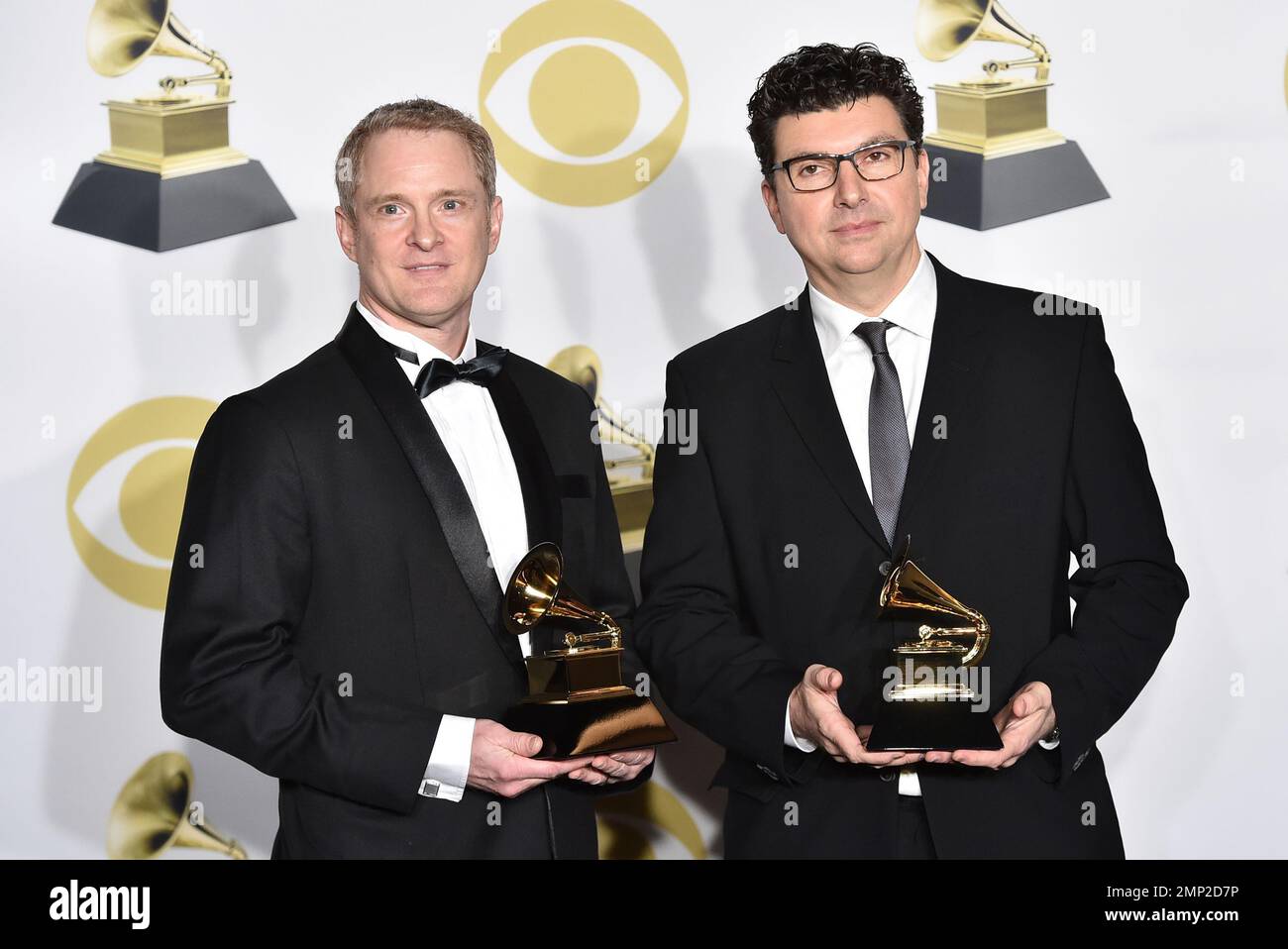 John Hanes, left, and Serban Ghenea pose in the press room with the ...