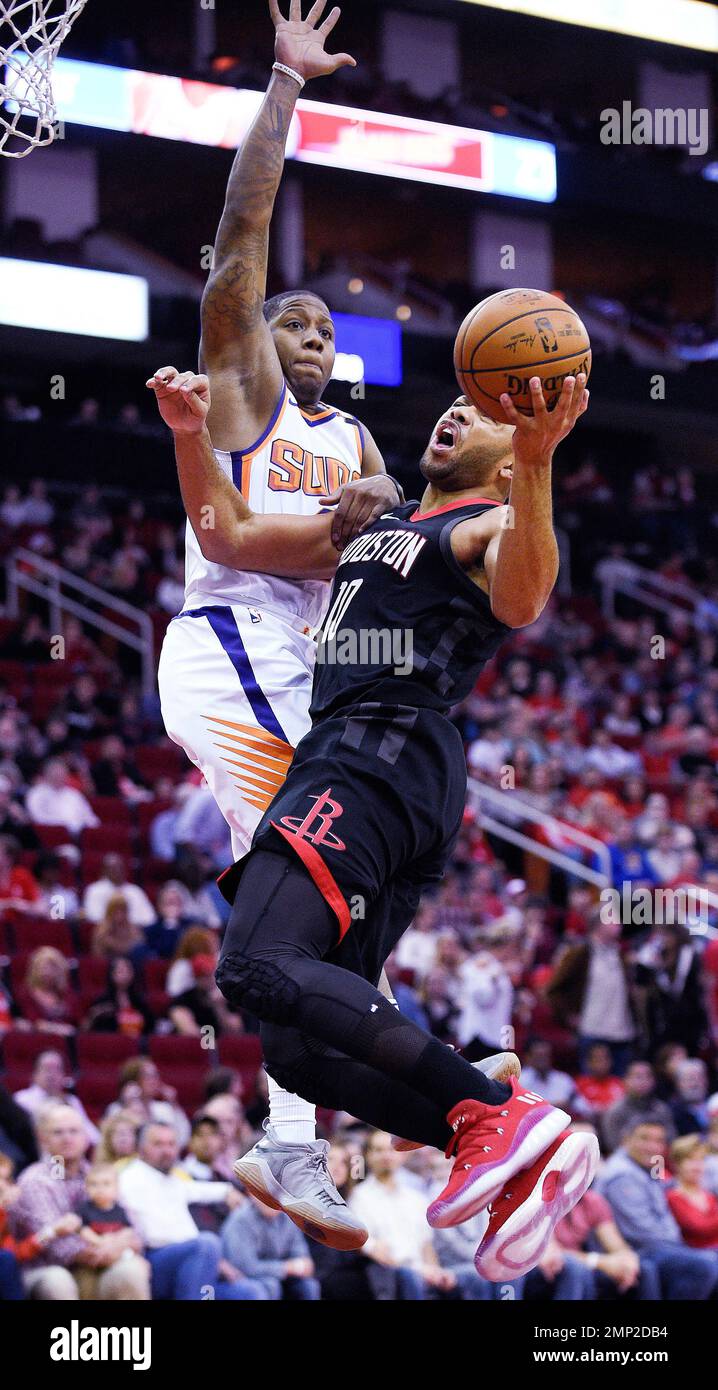 Houston Rockets guard Eric Gordon, right, drives to the basket as ...
