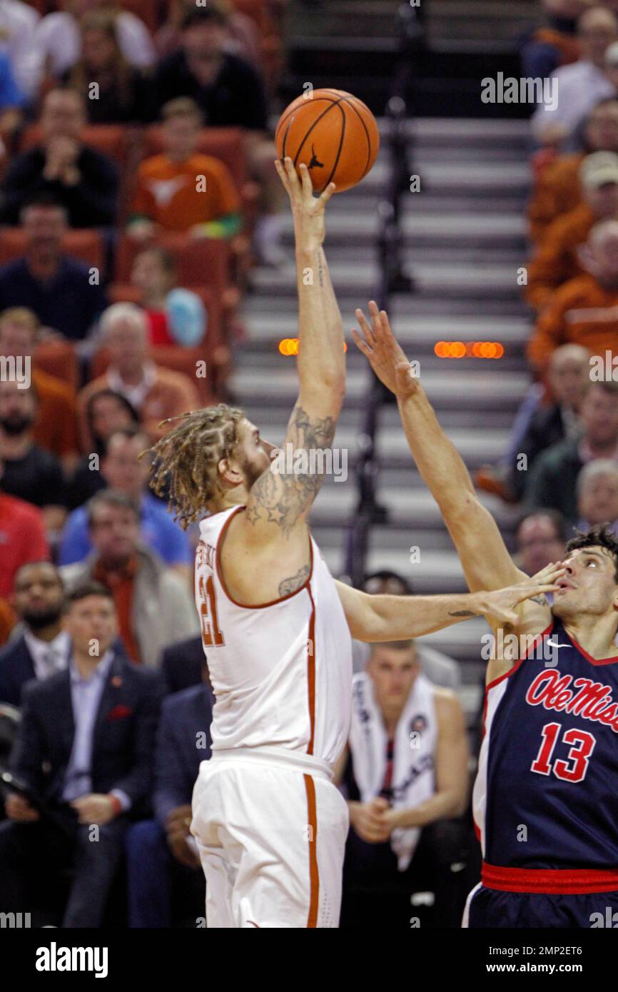 Texas forward Dylan Osetkowski, left, puts up a shot against ...