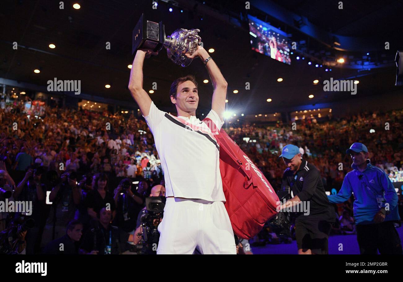 Switzerland's Roger Federer holds his trophy aloft after defeating ...