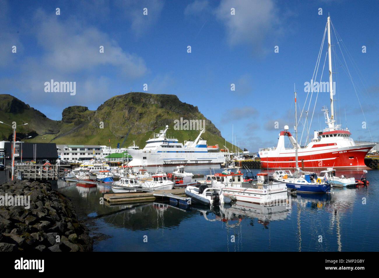 Iceland, Island of Heimaey: a colourful assortment of vessels reflected ...