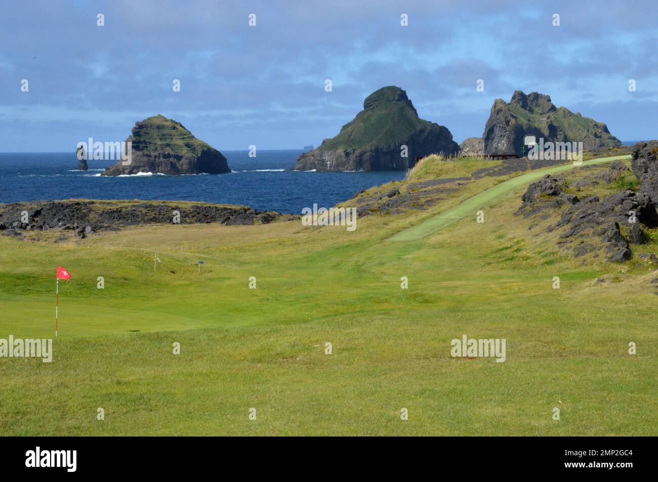 Iceland, Island of Heimaey: the last green of the golf course, with ...