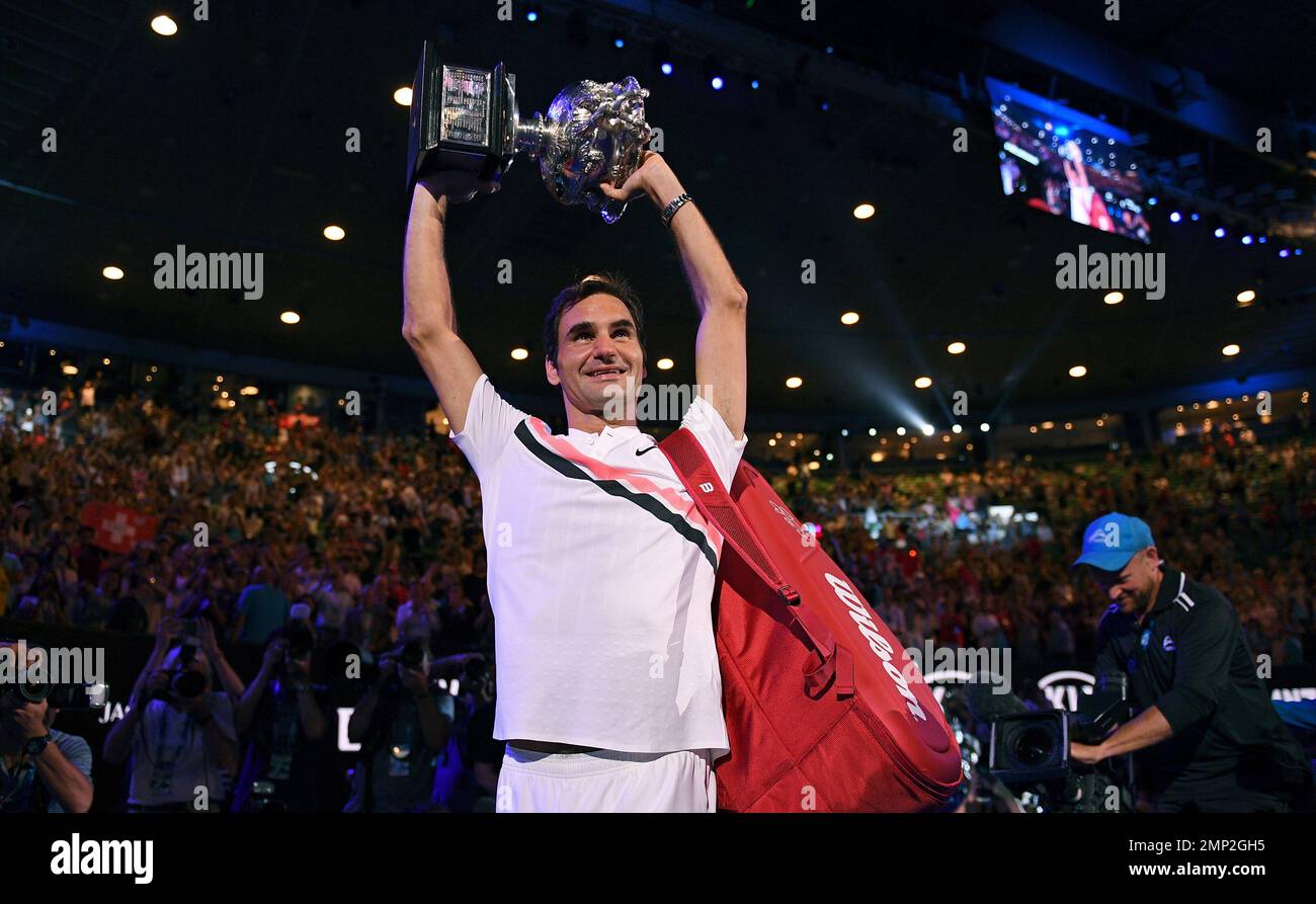 Switzerland's Roger Federer holds his trophy aloft after defeating ...