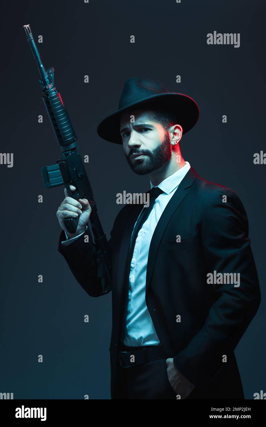 Man, suit or automatic rifle on dark studio background in secret spy ...