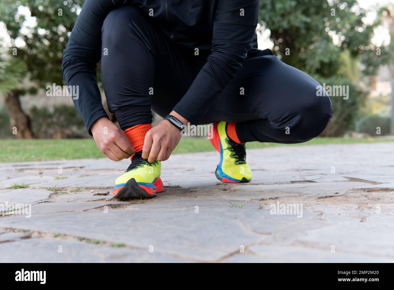 Male athlete tying shoe hi-res stock photography and images - Alamy