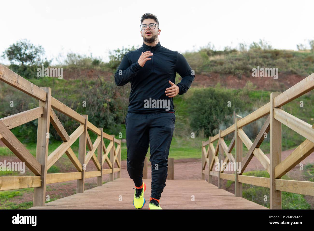 Man jogging across wooden bridge hi-res stock photography and images ...