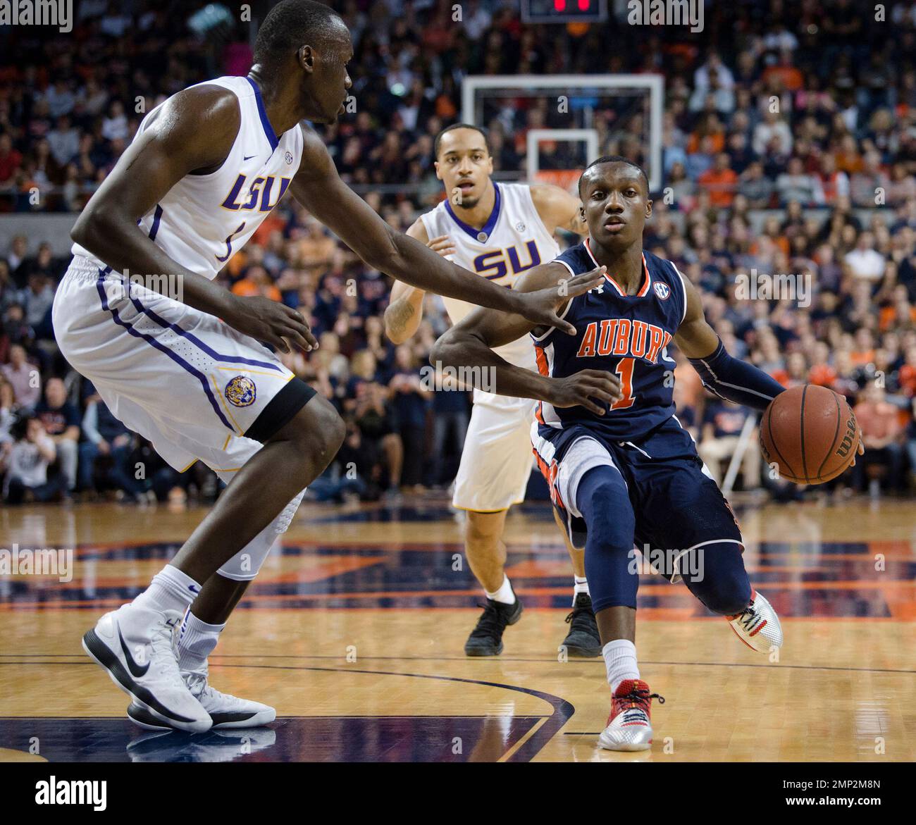 Auburn guard Jared Harper (1) drives as LSU forward Duop Reath (1 ...