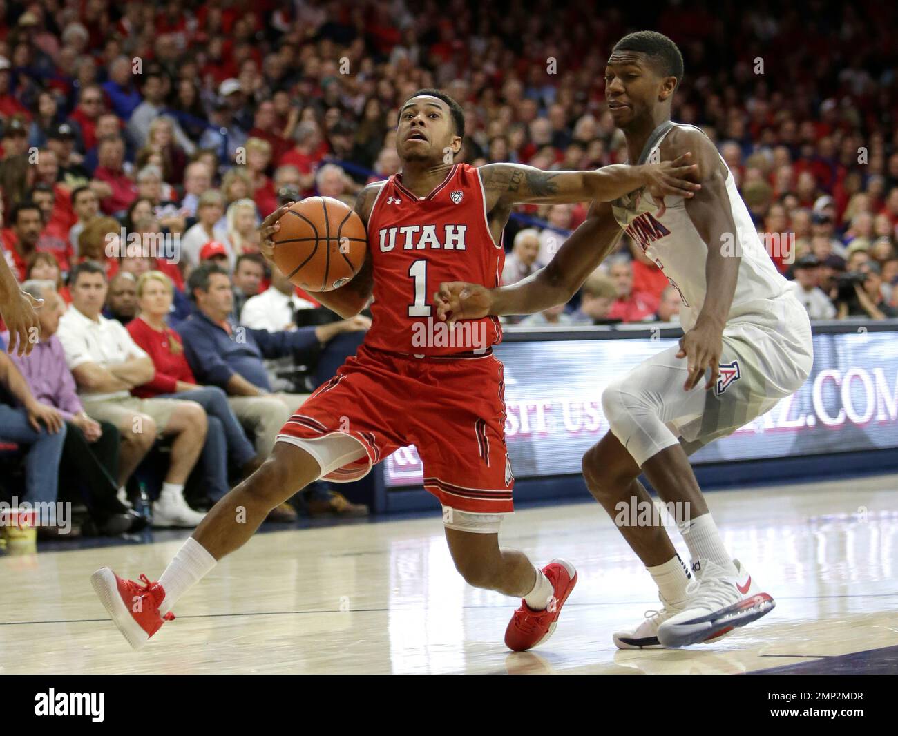 Utah guard Justin Bibbins (1) drives past Arizona forward Keanu Pinder ...