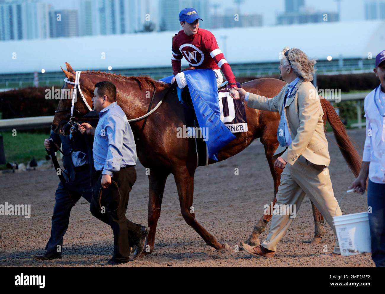 Jockey Florent Geroux, left, walks with trainer Steve Asmussen, right ...