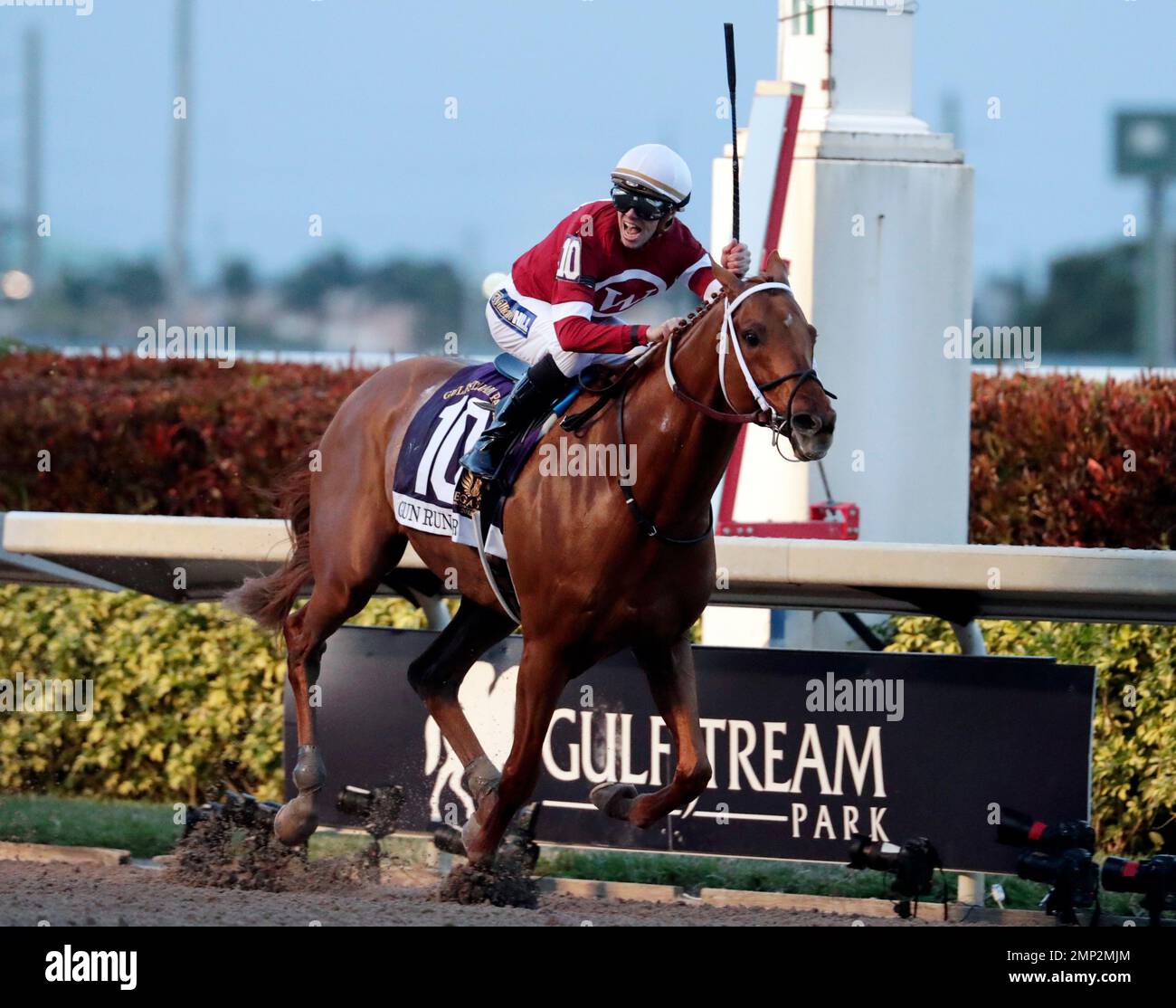 Jockey Florent Geroux celebrates as Gun Runner crosses the finish line ...