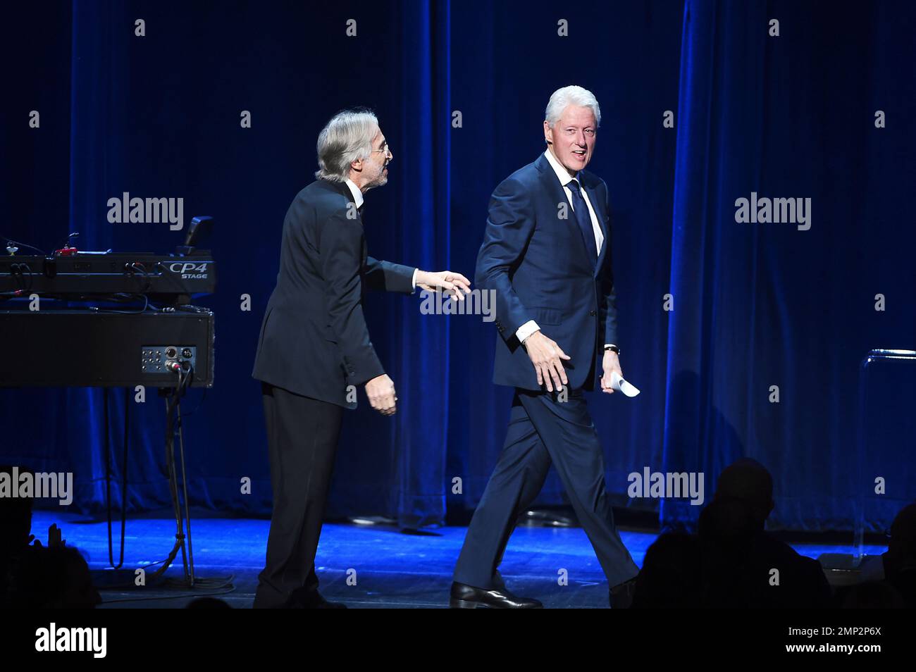 Neil Portnow, left, and Bill Clinton speak onstage at the 2018 ...