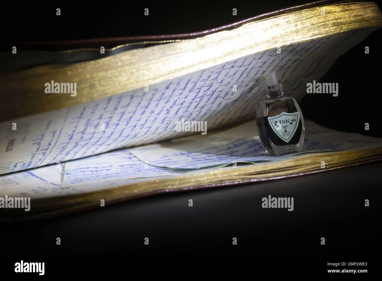 old handwritten diary with a little bottle of ink Stock Photo - Alamy