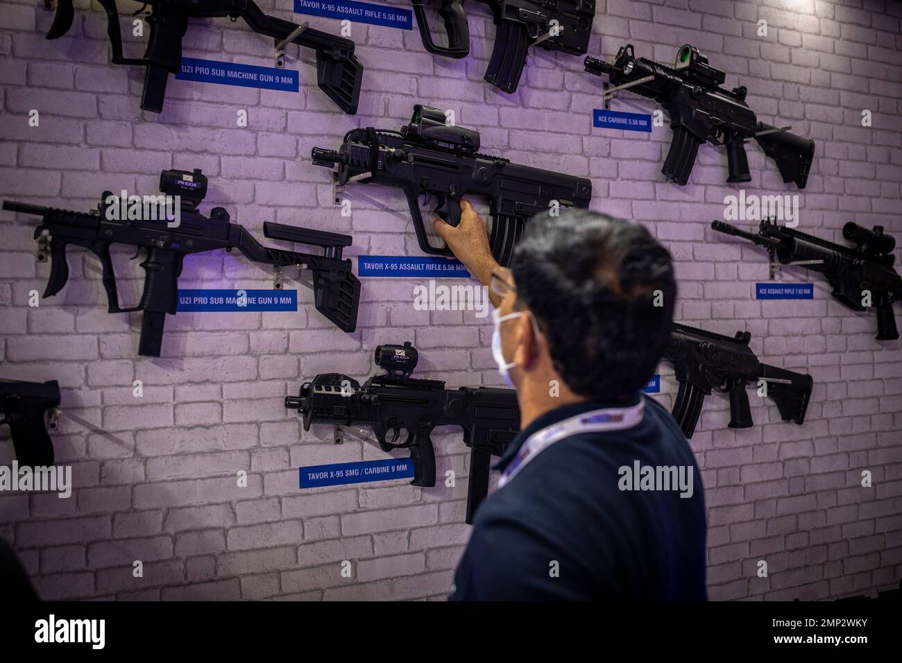 FILE- An exhibitor adjusts guns manufactured by PLR Systems Private ...