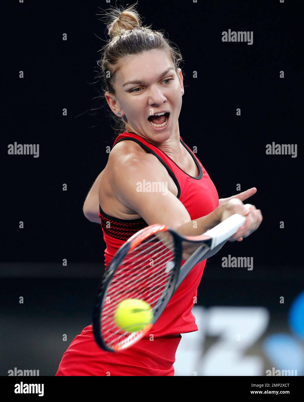 Romania's Simona Halep hits a forehand to Denmark's Caroline Wozniacki ...