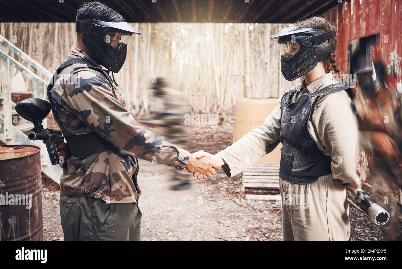 Handshake, paintball team and congratulations or support, sports game ...