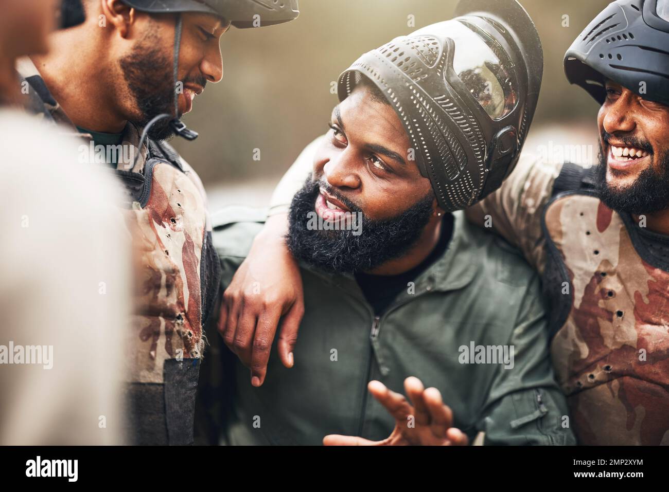 Paintball team, sport game strategy and communication of men playing ...