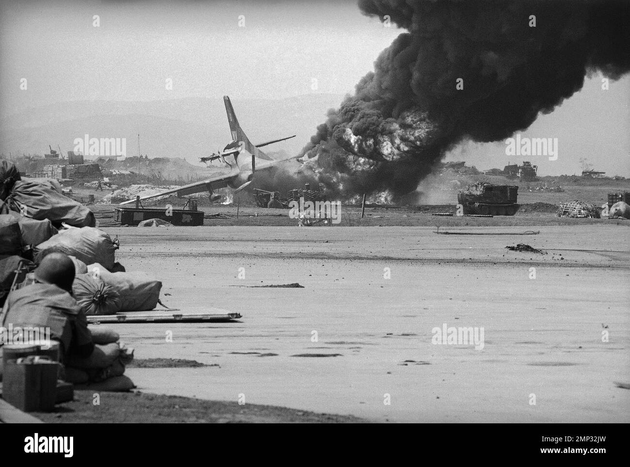 A U.S. Air Force C-123 burns at Khe Sanh as Communist shelling finishes ...