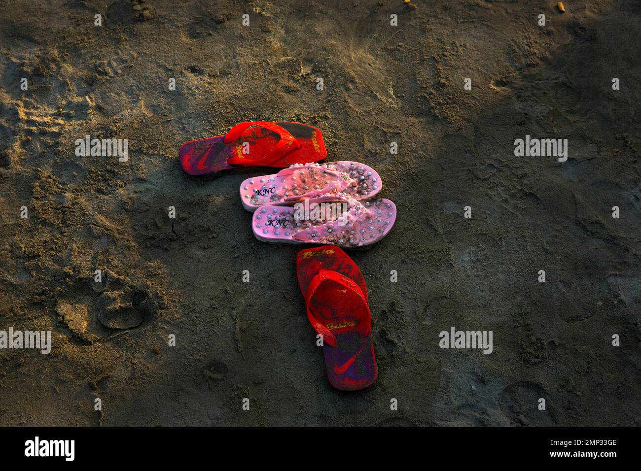 Flip-flops belonging to a Bangladeshi couple lie on the beach as they ...