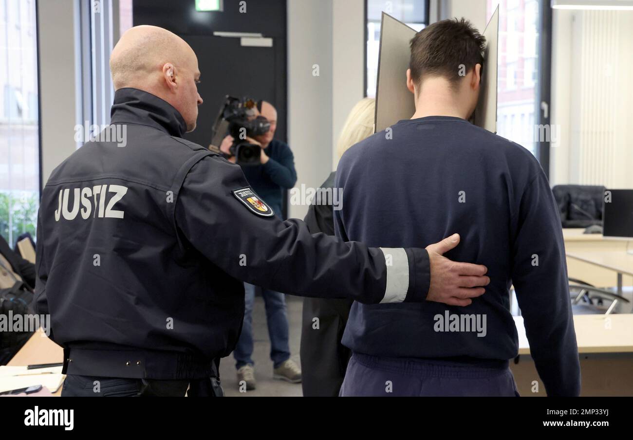 Rostock, Germany. 31st Jan, 2023. A judicial officer (l-r) leads the ...