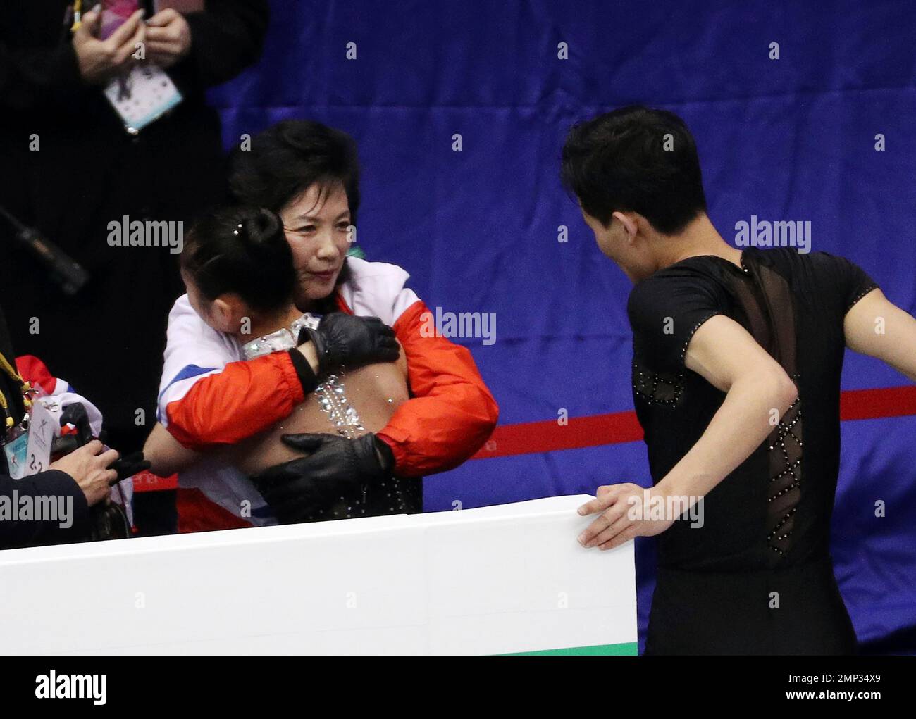 Tae Ok Ryom, center and Ju Sik Kim of North Korea hug their coach after ...