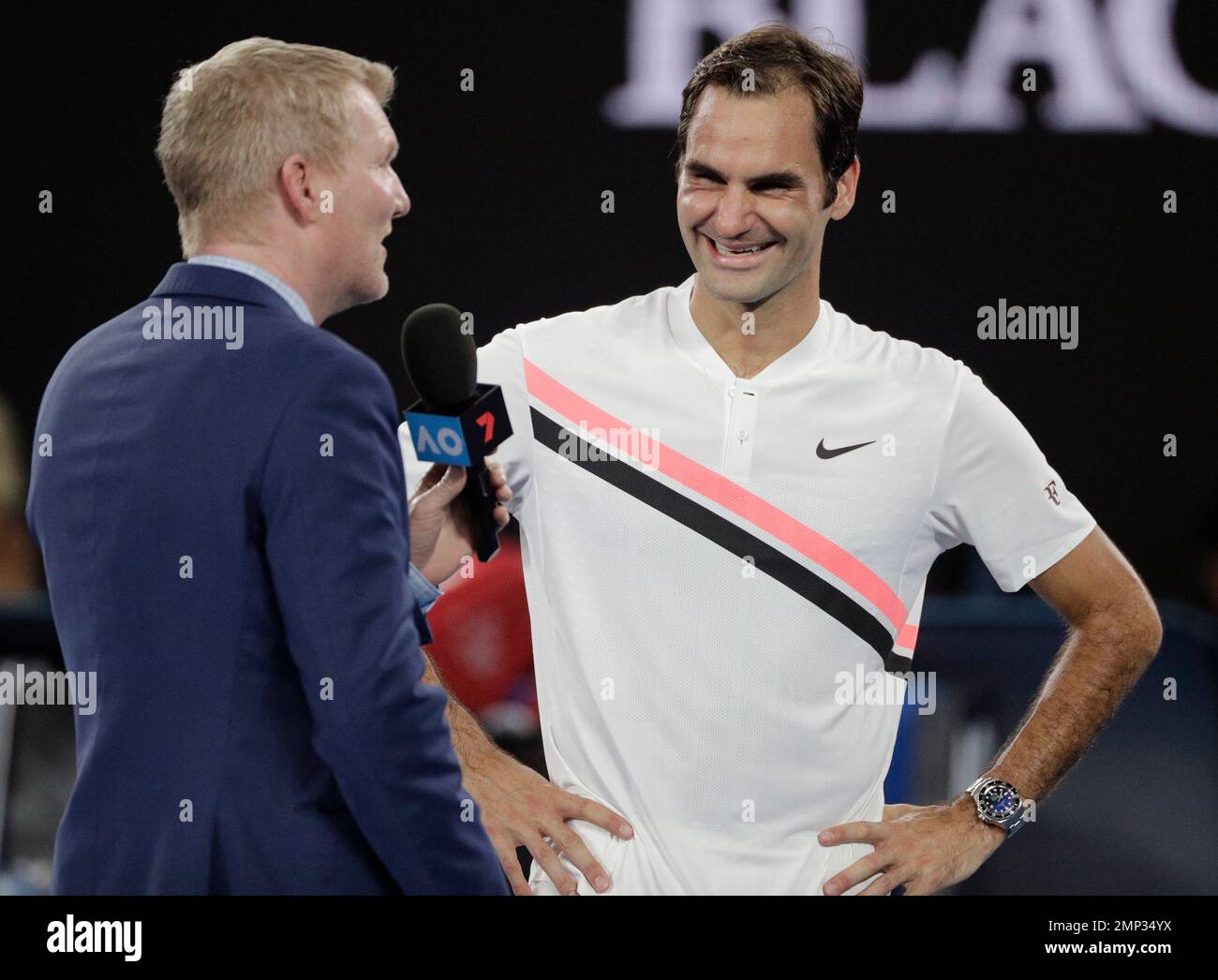 Switzerland's Roger Federer laughs as he is interviewed by former ...
