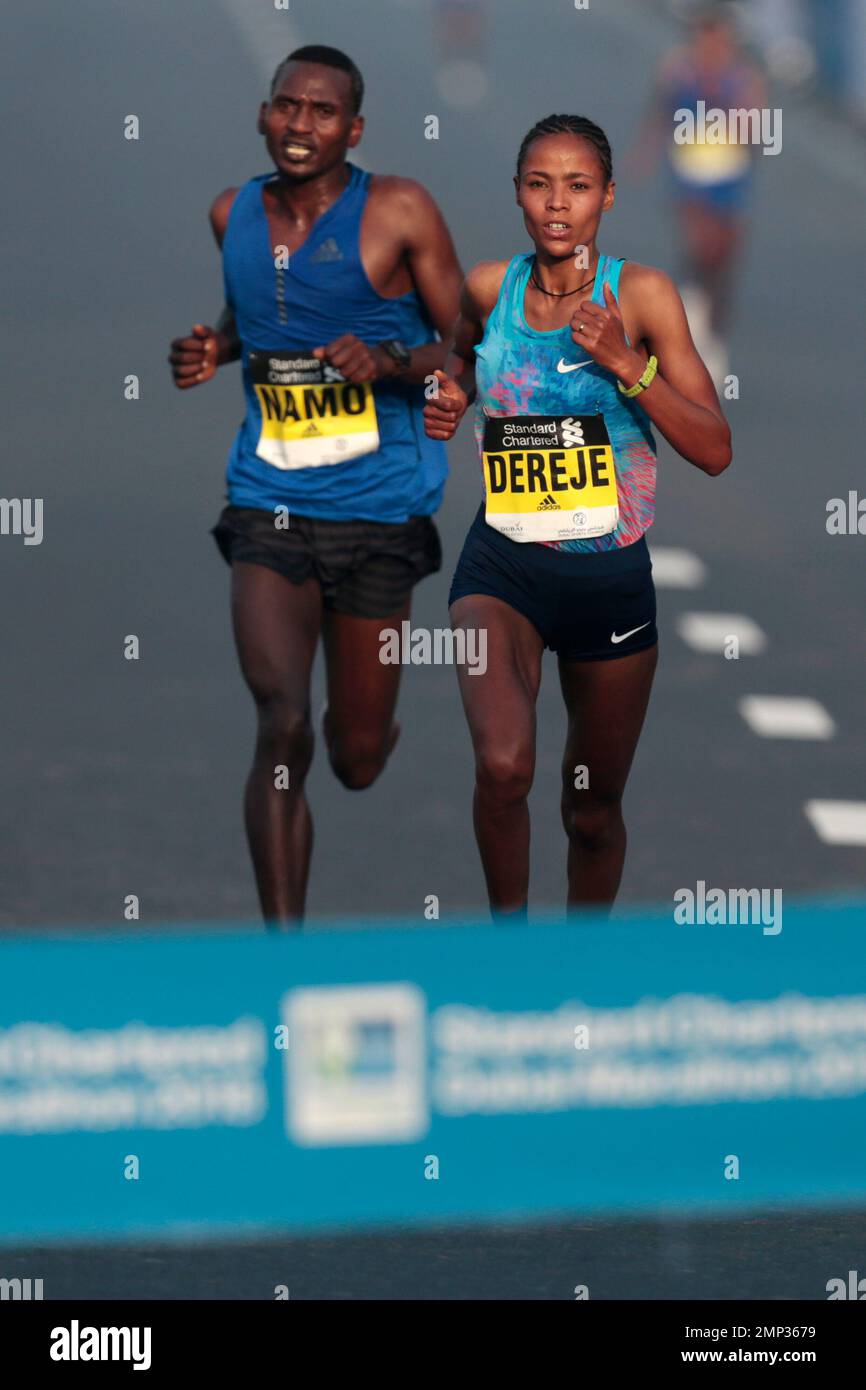 Ethiopia's Roza Dereje Bekele, right, races towards the finish line on ...