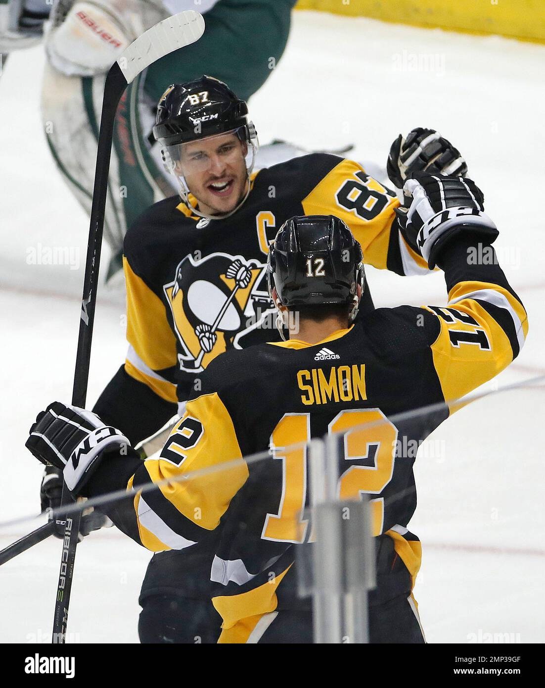 Pittsburgh Penguins' Dominik Simon (12) celebrates his goal with Sidney ...