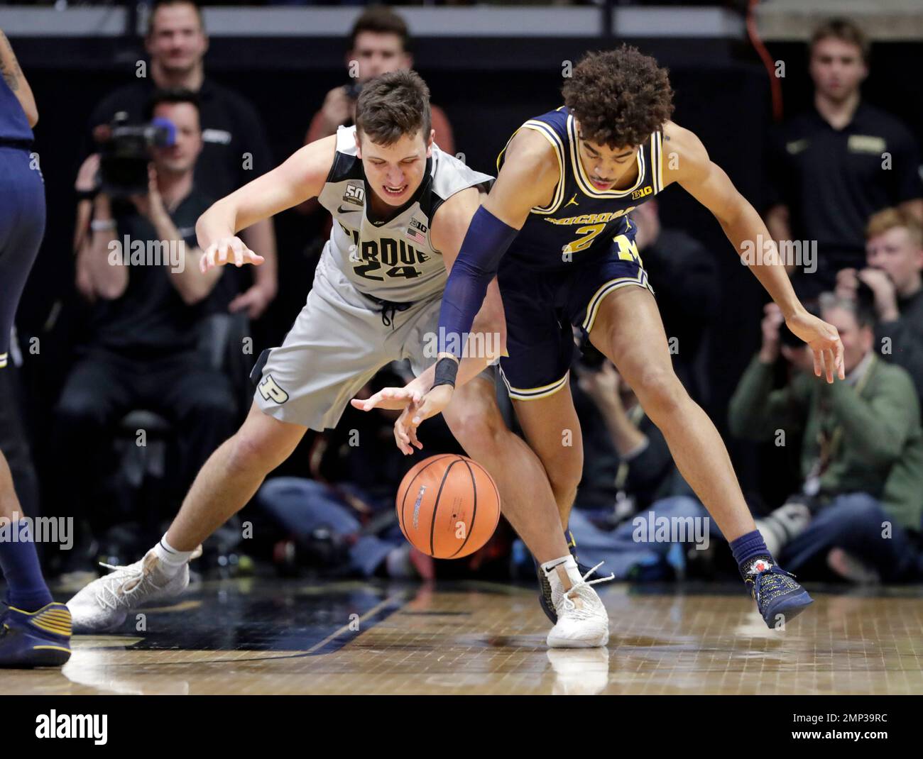 Michigan guard Jordan Poole (2) and Purdue forward Grady Eifert (24) go ...